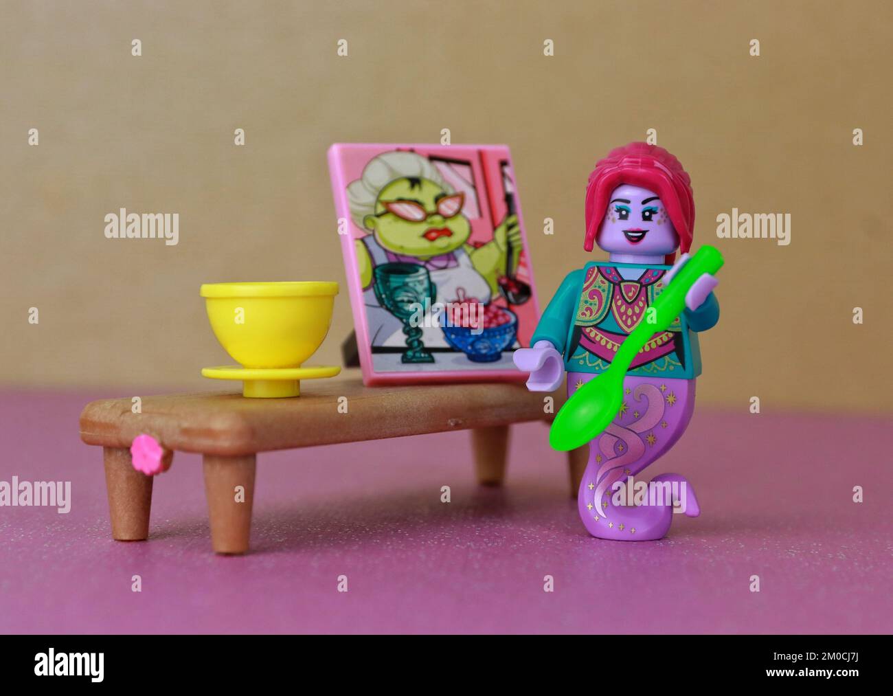 Toy female-octopus character cooking in a kitchen with a spoon and a ...