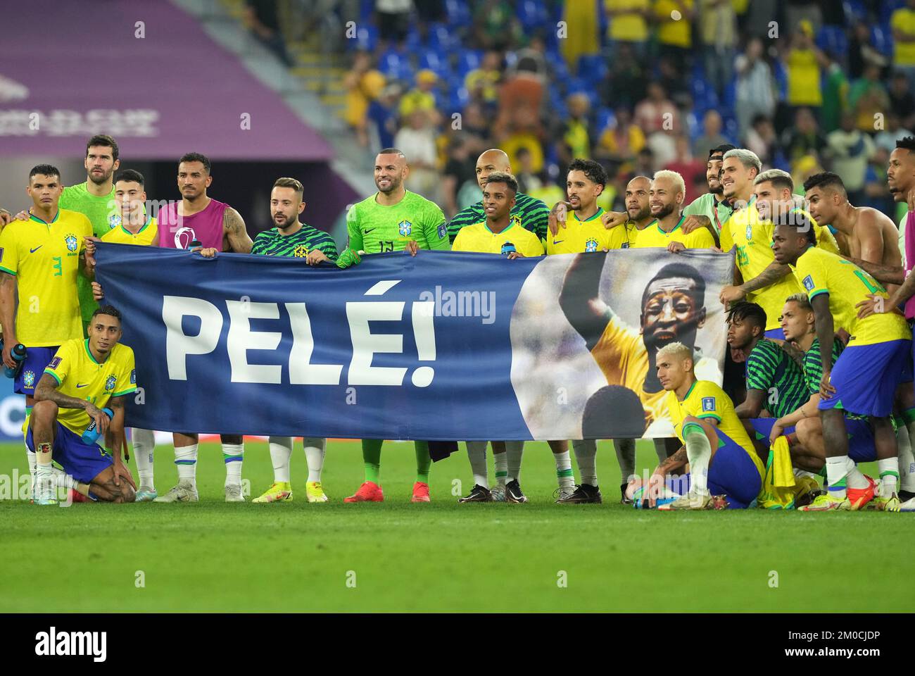 Brazil players bring a Pele banner on to the pitch following the FIFA ...