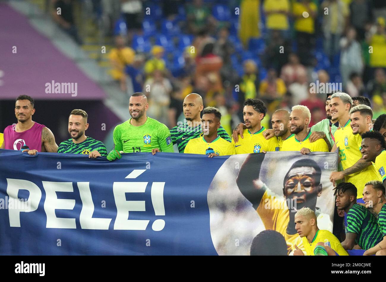 Brazil players bring a Pele banner on to the pitch following the FIFA ...
