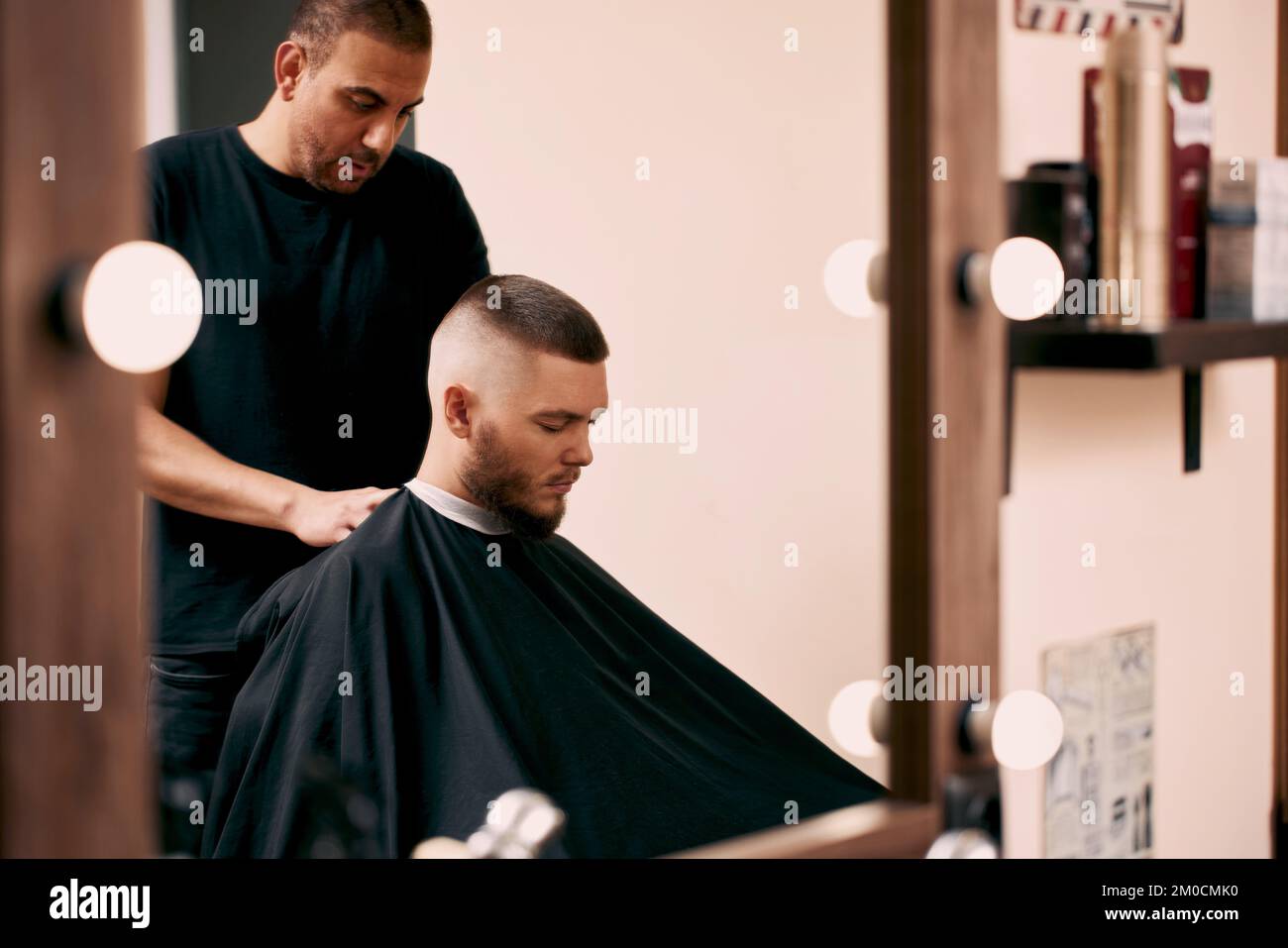 Barber and satisfied bearded man in front of the mirror Stock Photo - Alamy