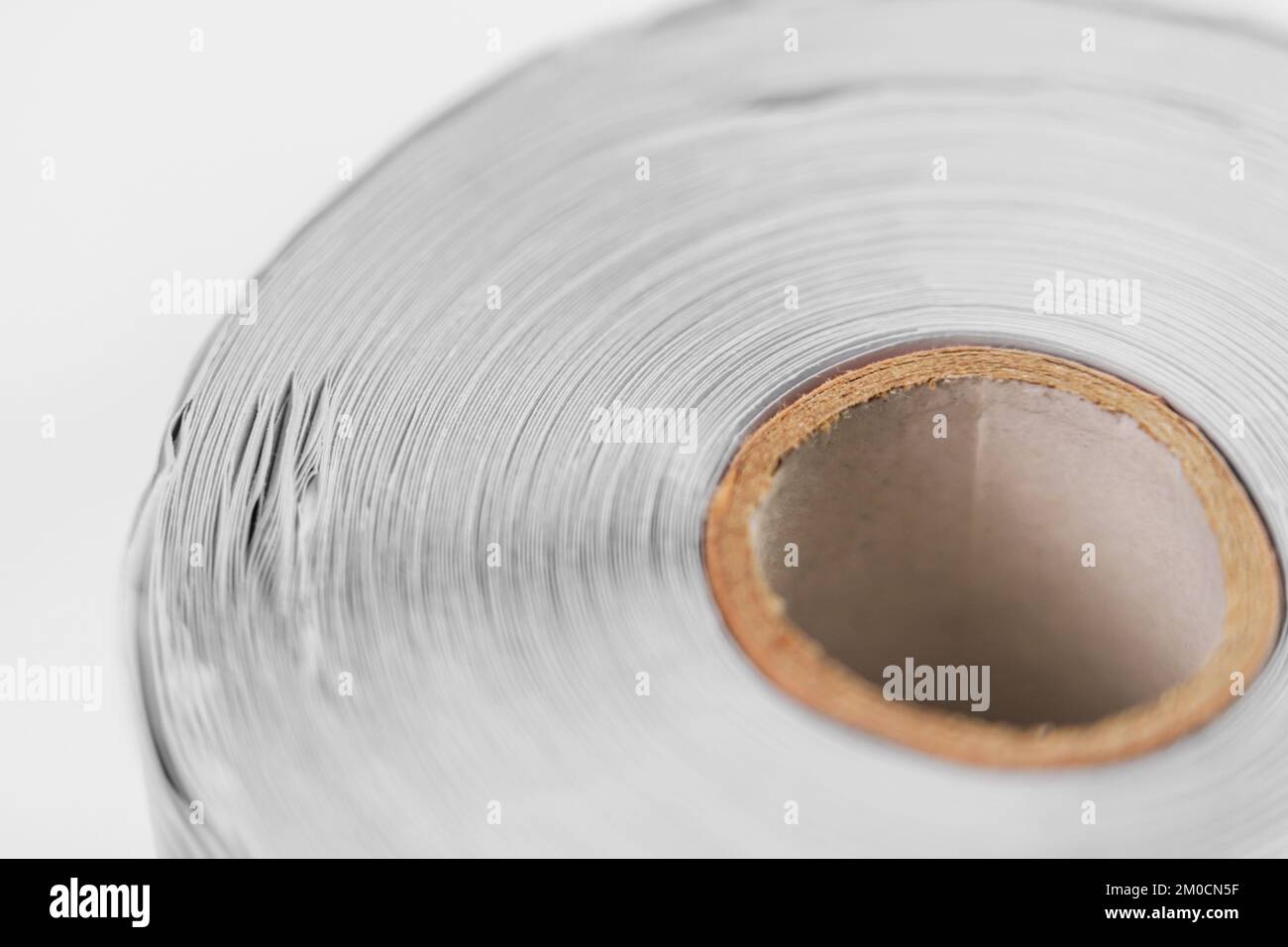 Rolled up paper roll on white background. Rotating recycled cellulose ...