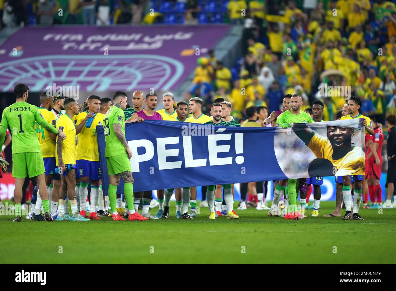 Brazil players bring a Pele banner on to the pitch following the FIFA ...