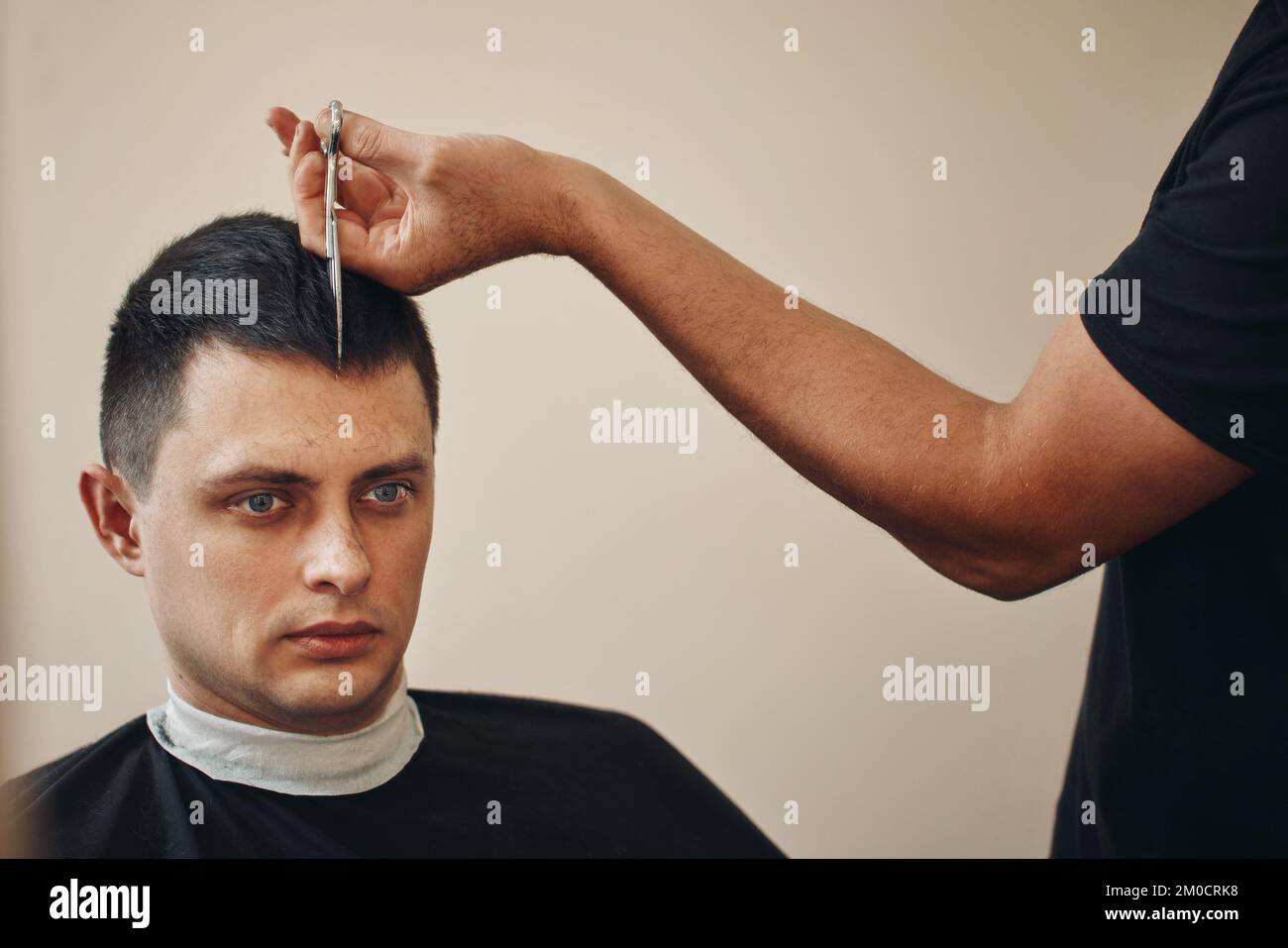 hairdresser does haircut for man in barber shop Stock Photo - Alamy