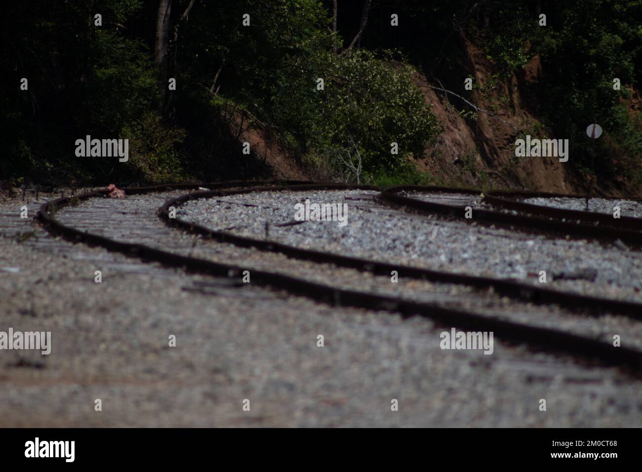 A curvy railroad track turning right into the distance Stock Photo - Alamy