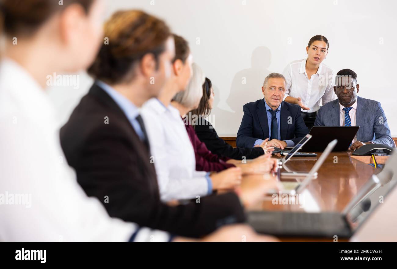 Executive team holding corporate meeting at office with assistance ...