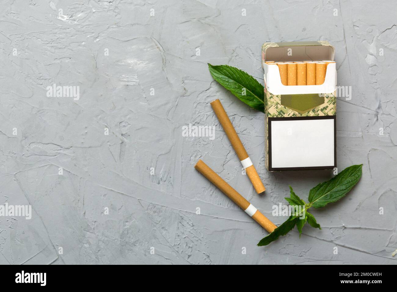Pack of menthol cigarettes and fresh mint on colored table, Menthol ...
