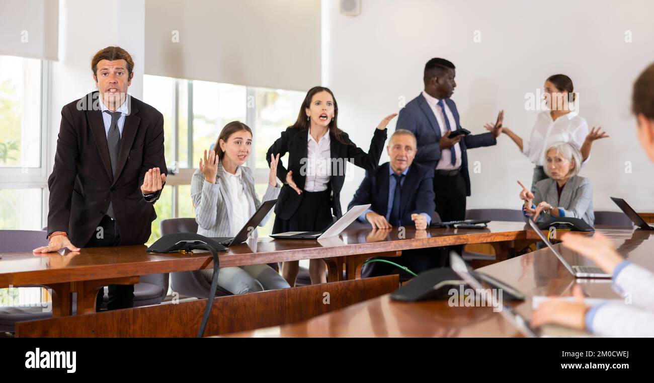 Group of business people arguing in meeting room Stock Photo - Alamy