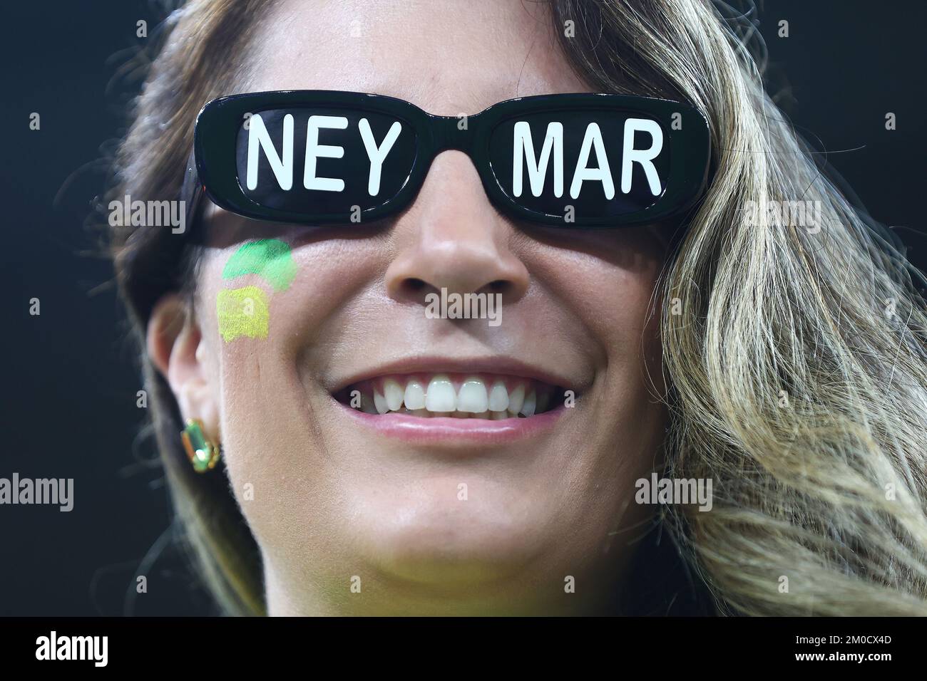 Doha, Qatar. 05th Dec, 2022. A Brazil fan wearing Neymar glasses looks ...