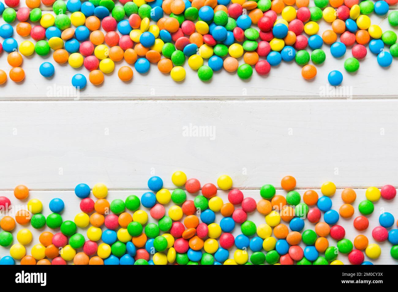 Mixed collection of colorful candy, on colored background. Flat lay ...