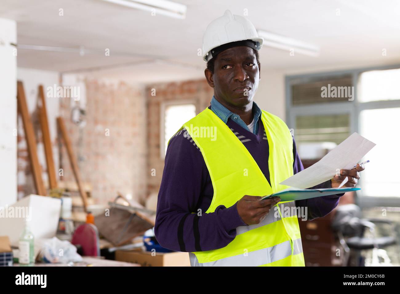 Portrait of man builder with project documentation Stock Photo - Alamy