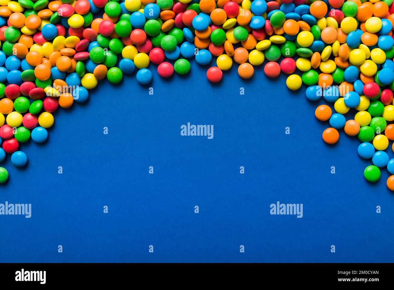 Mixed collection of colorful candy, on colored background. Flat lay ...