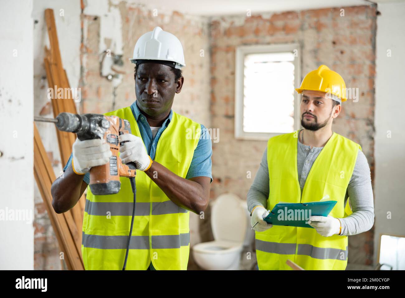 Man construction worker using demolition hammer in apartment Stock ...