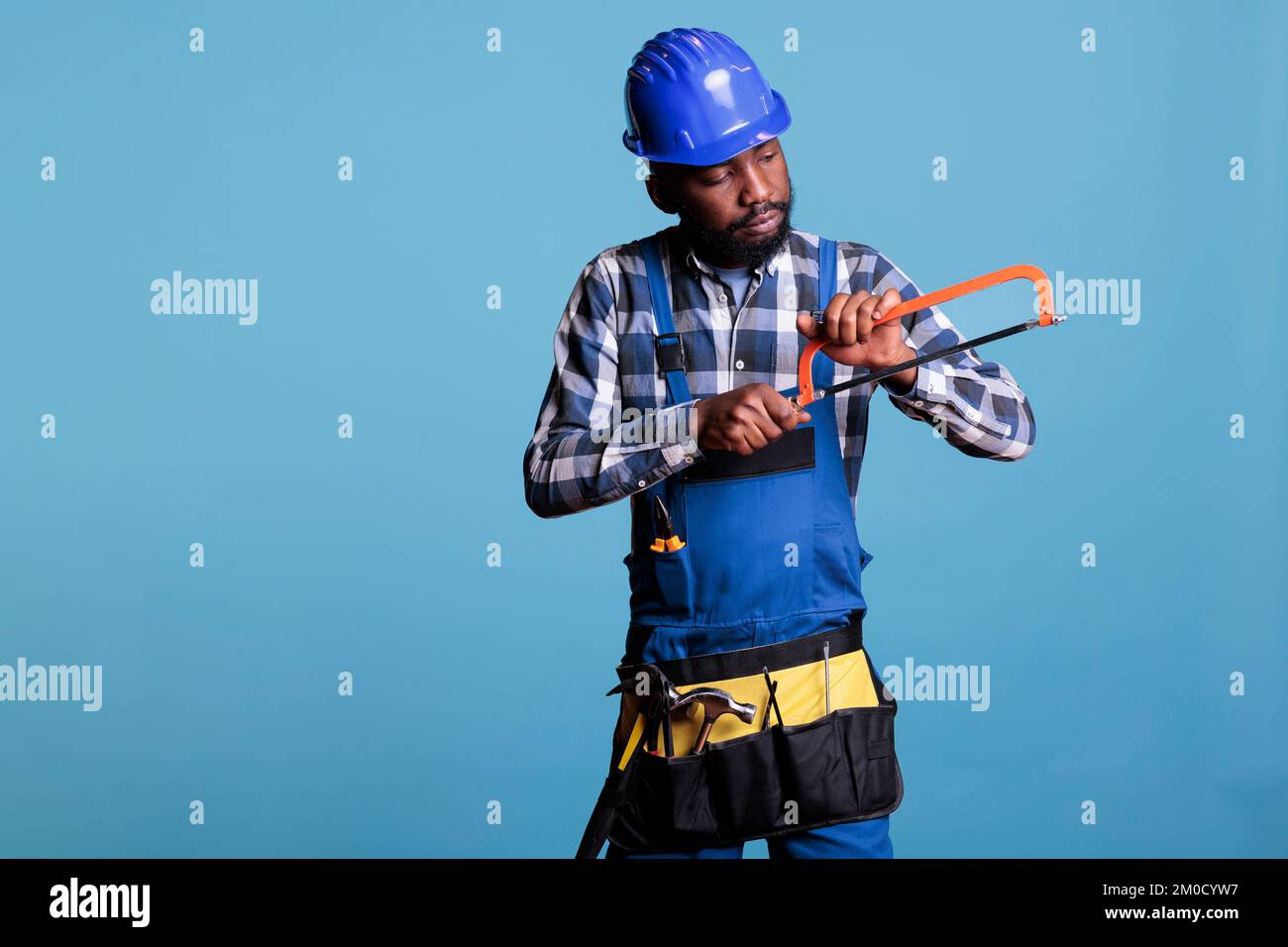 African american carpenter handling hand saw with uniform and ...