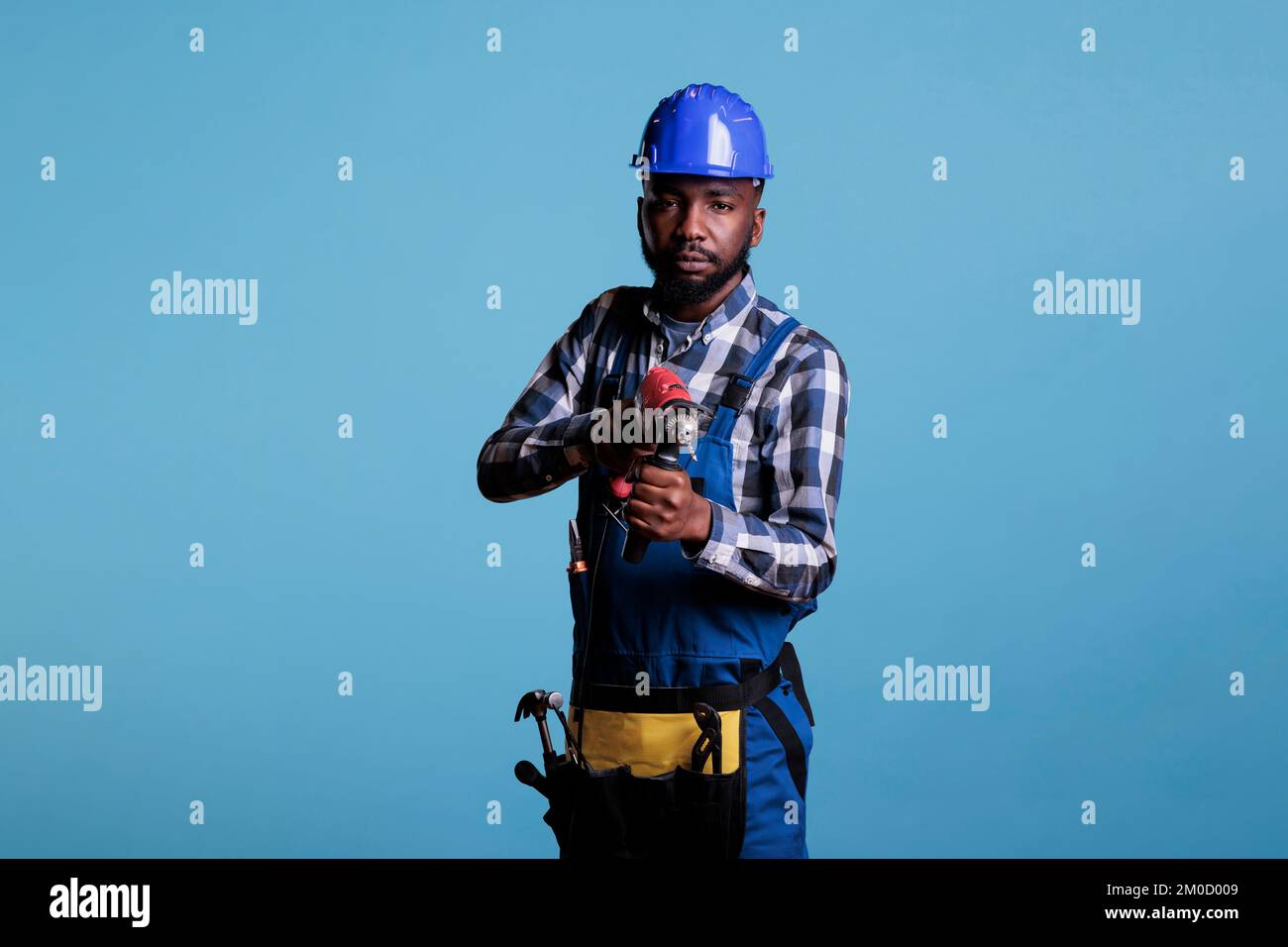 African american male holding a drill like a gun and pointing at the ...