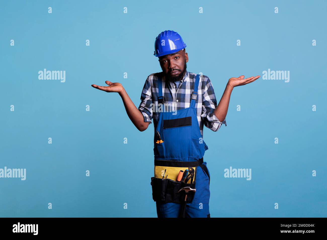 Confused african american builder making I dont know gesture to camera ...
