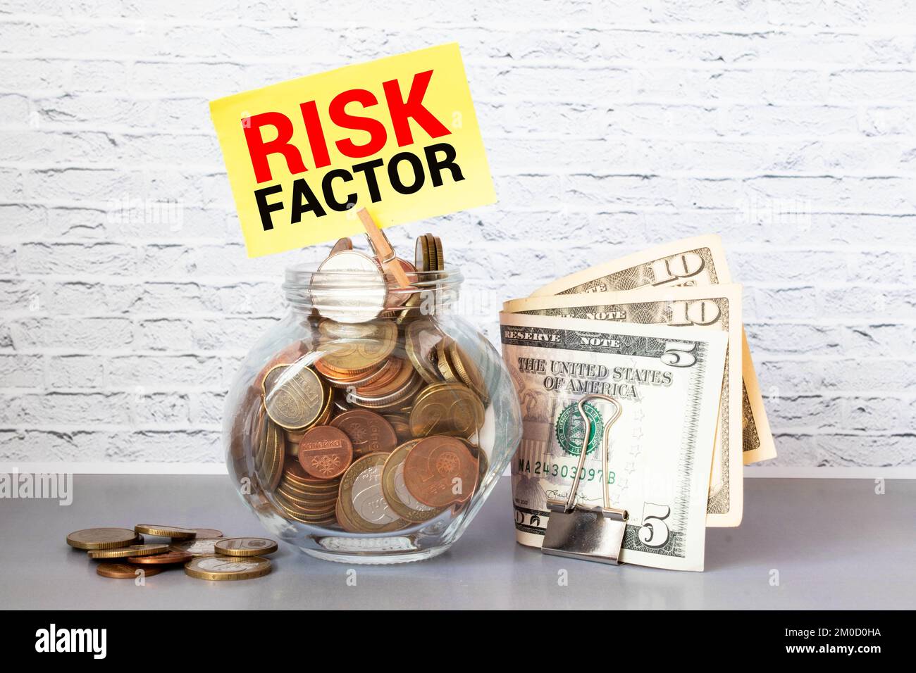 Risk Factor text on open notepad near desk clock and yellow sticky ...