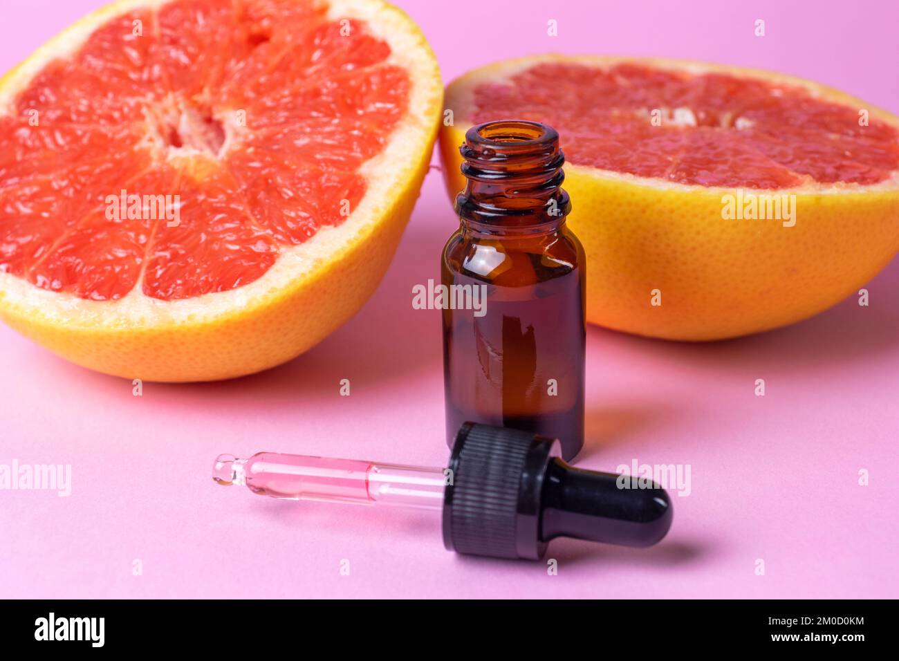 Grapefruit essential oil with fresh grapefruit and glass brown bottles ...