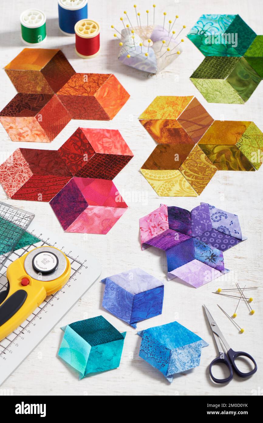Preparing of bright diamond pieces of fabrics for sewing quilt, sewing ...