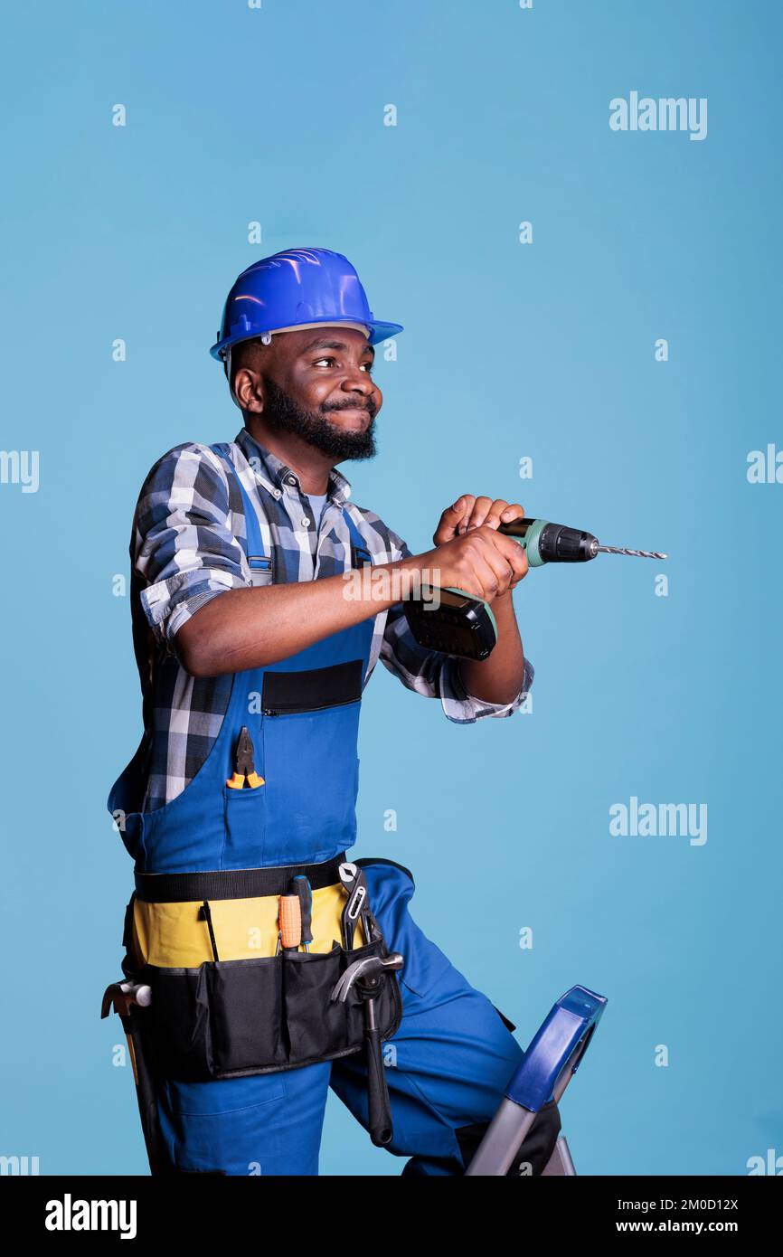 African american contractor drilling nails with electric power drill ...