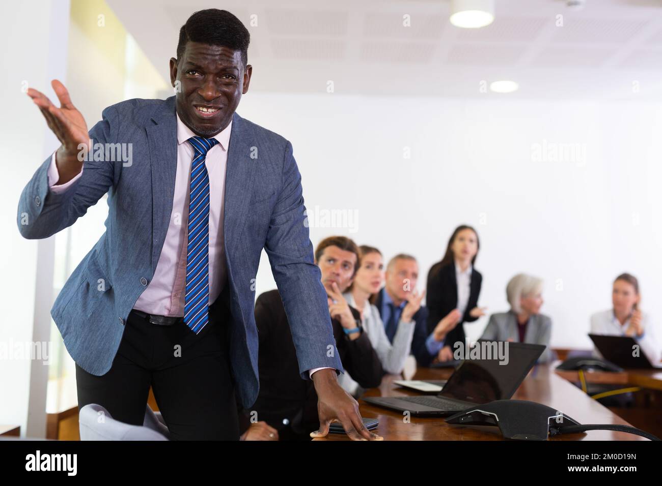 Agitated mature african businessman arguing at corporate team meeting ...
