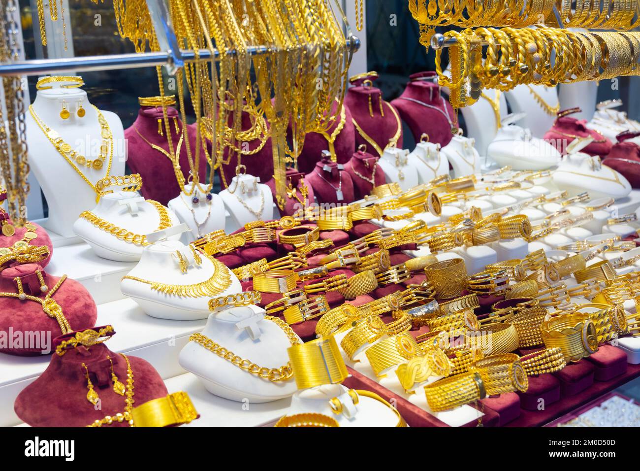 Gold jewelry at showcase of jewelry shop. Gold items in shop windows ...