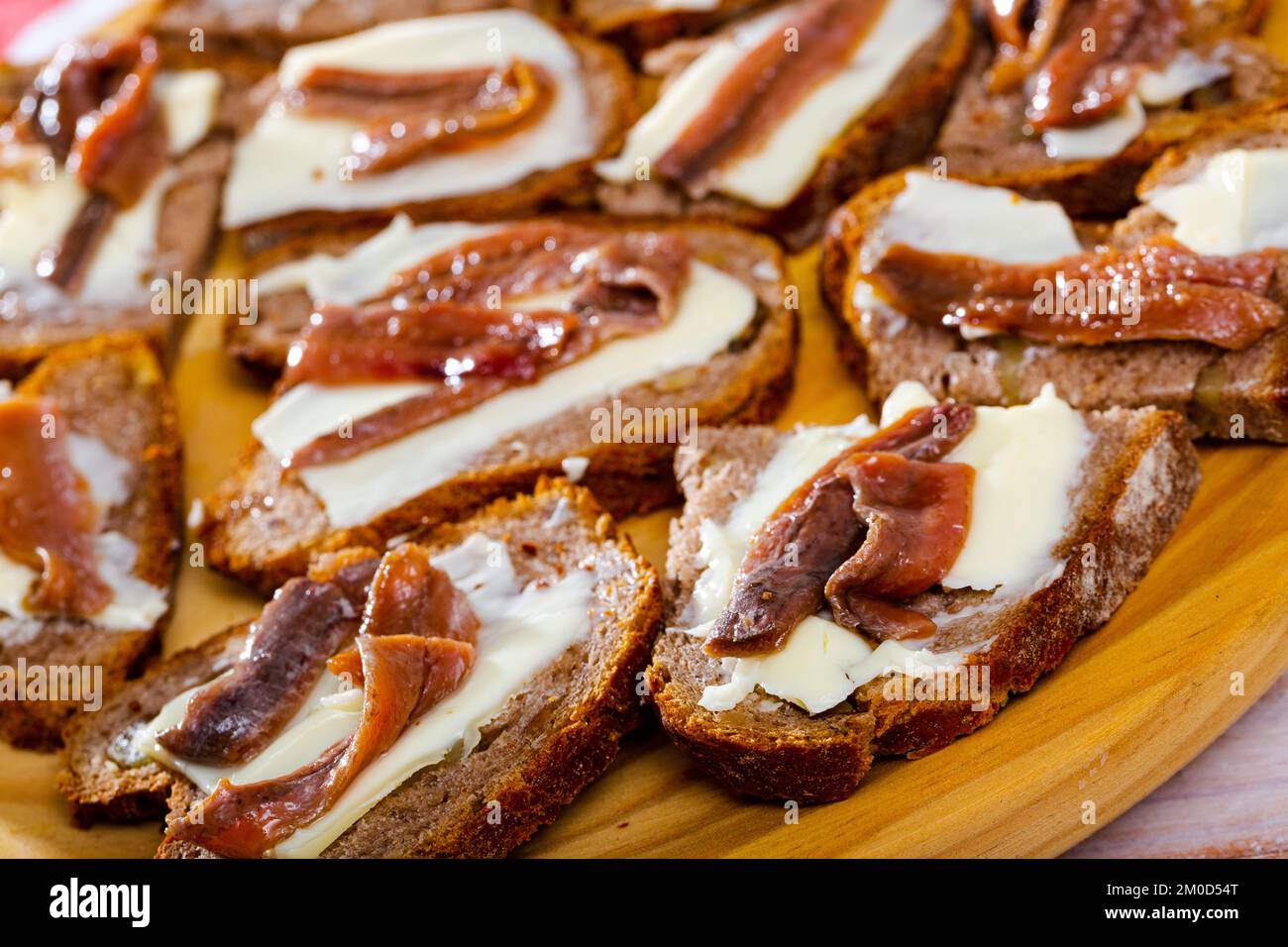 Black bread canapes with anchovies Stock Photo - Alamy