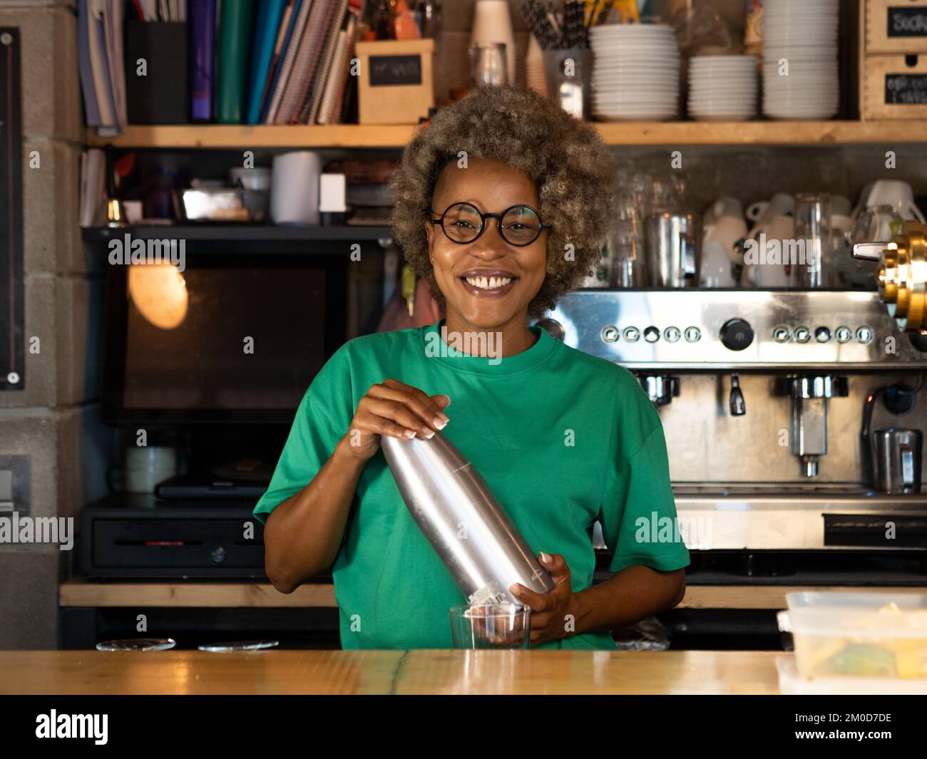 Portrait of smiling african american female waitress with afro hair ...