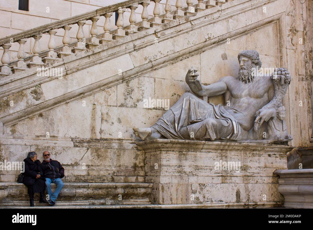 The statue observing the love between a married couple sharing a moment ...