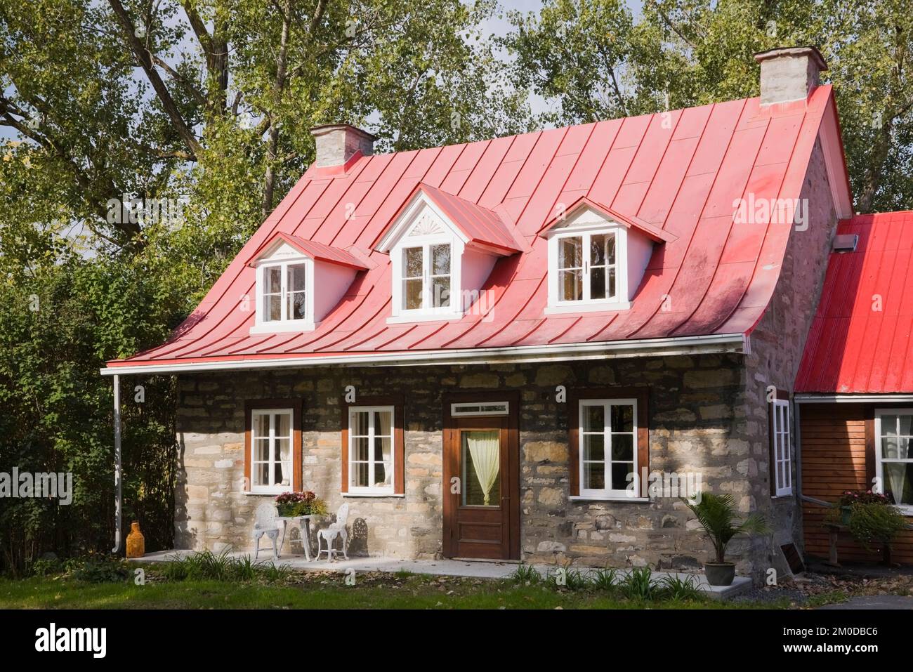 Old 1826 fieldstone home with red sheet metal roof in autumn Stock ...