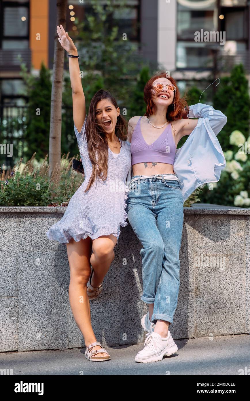 Two young women pose against the background of a building Stock Photo ...