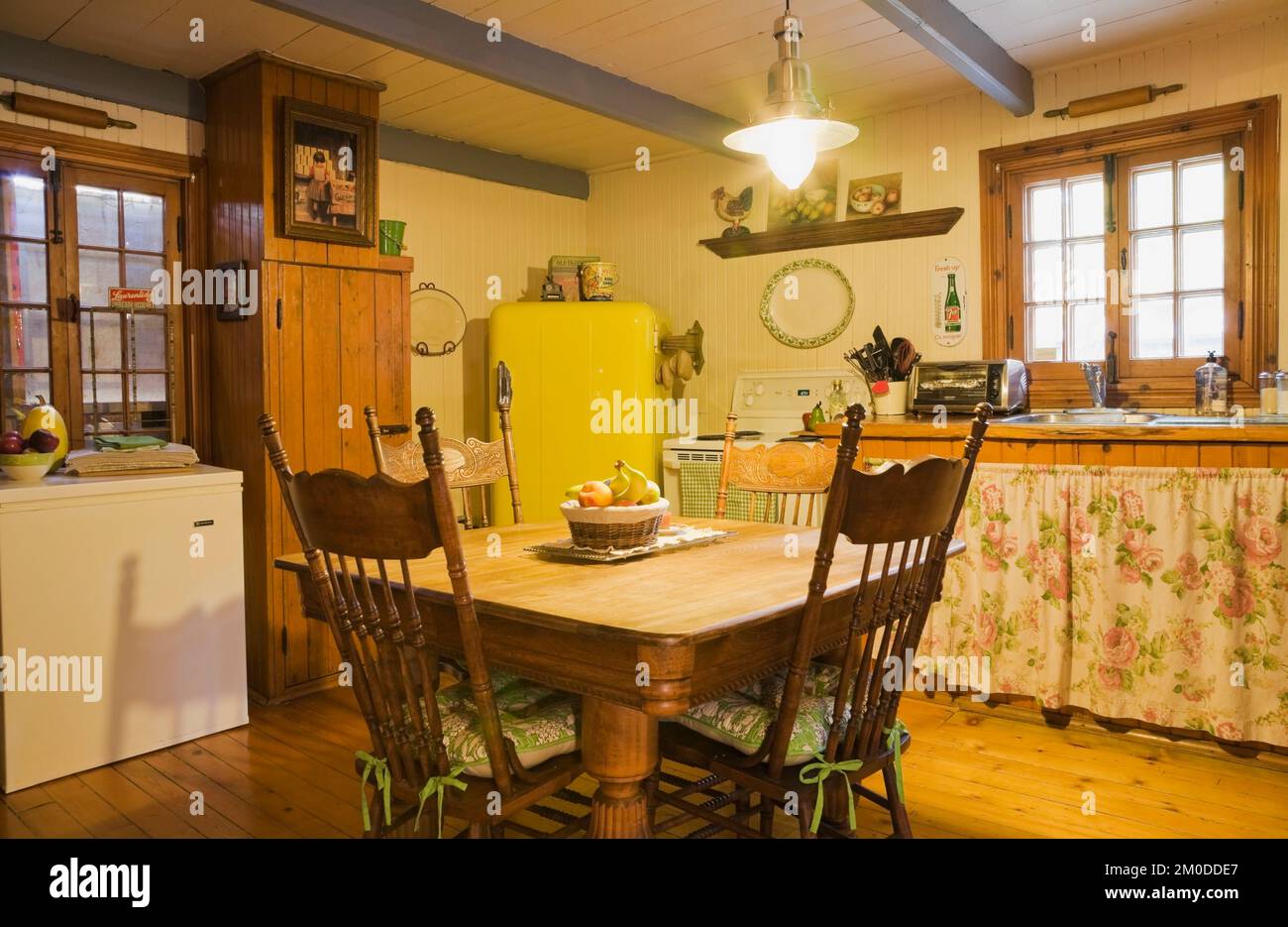 Antique table and high back wooden chairs and furnishings in kitchen ...