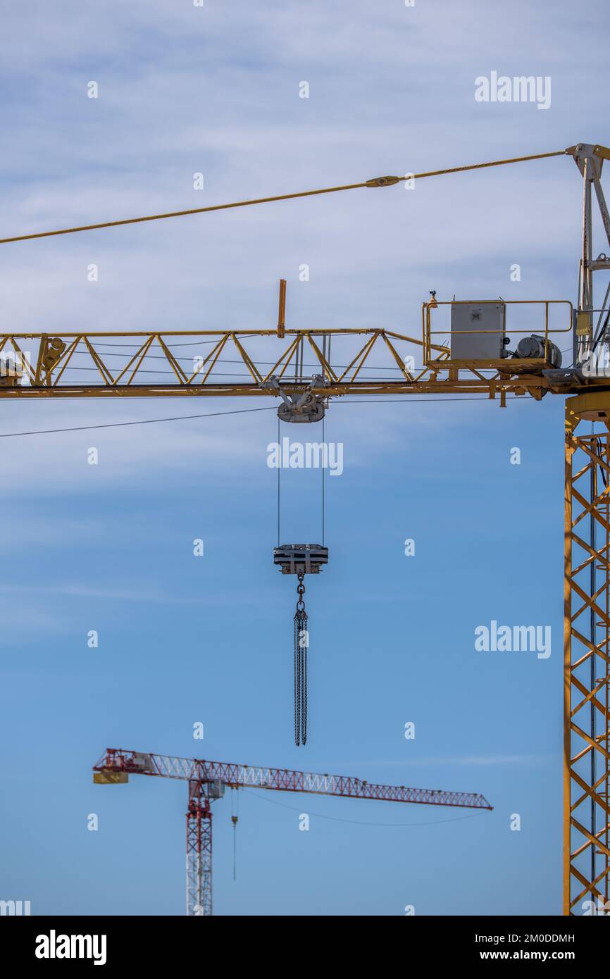 Several urban metallic cranes of different colors for the construction ...