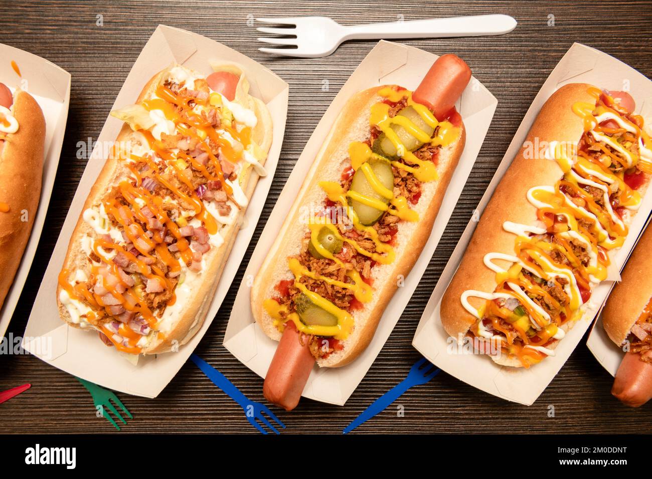 A string of delicious hot dogs from different recipes in paper gondolas ...