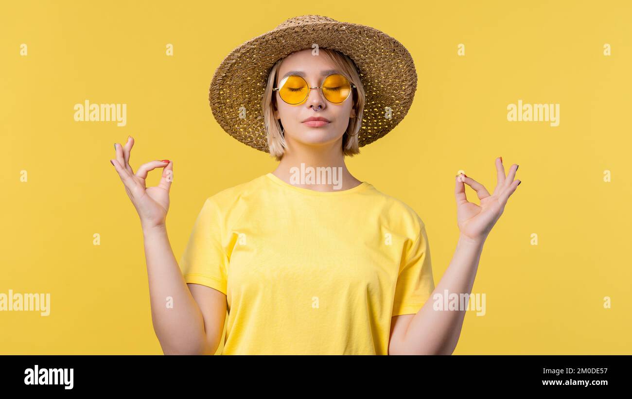 Calm woman relaxing, meditating, refuses stress. Sunny girl breathes ...