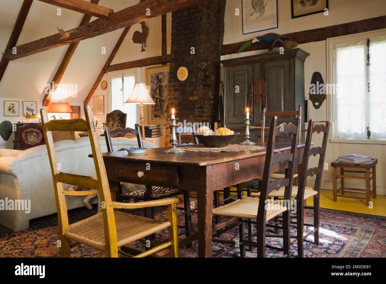 Antique table with high back chairs and furnishings in upstairs dining ...