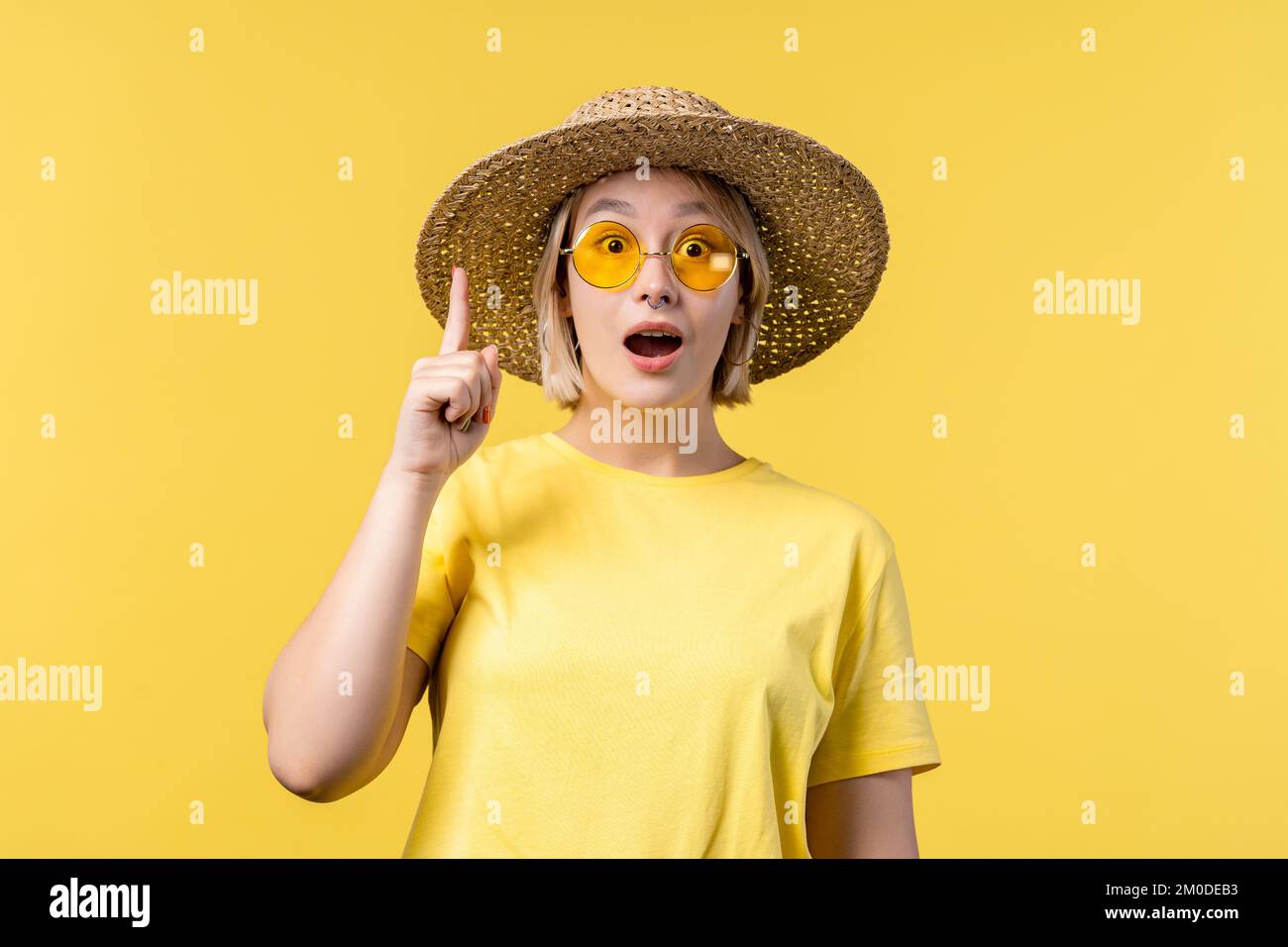 Summer pensive woman having idea eureka moment, pointing finger up on ...