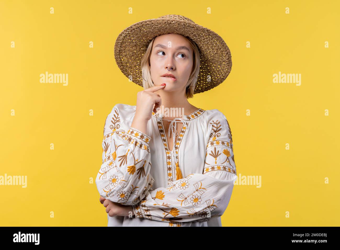 Ukrainian pensive woman on yellow background. Smart thinking student ...