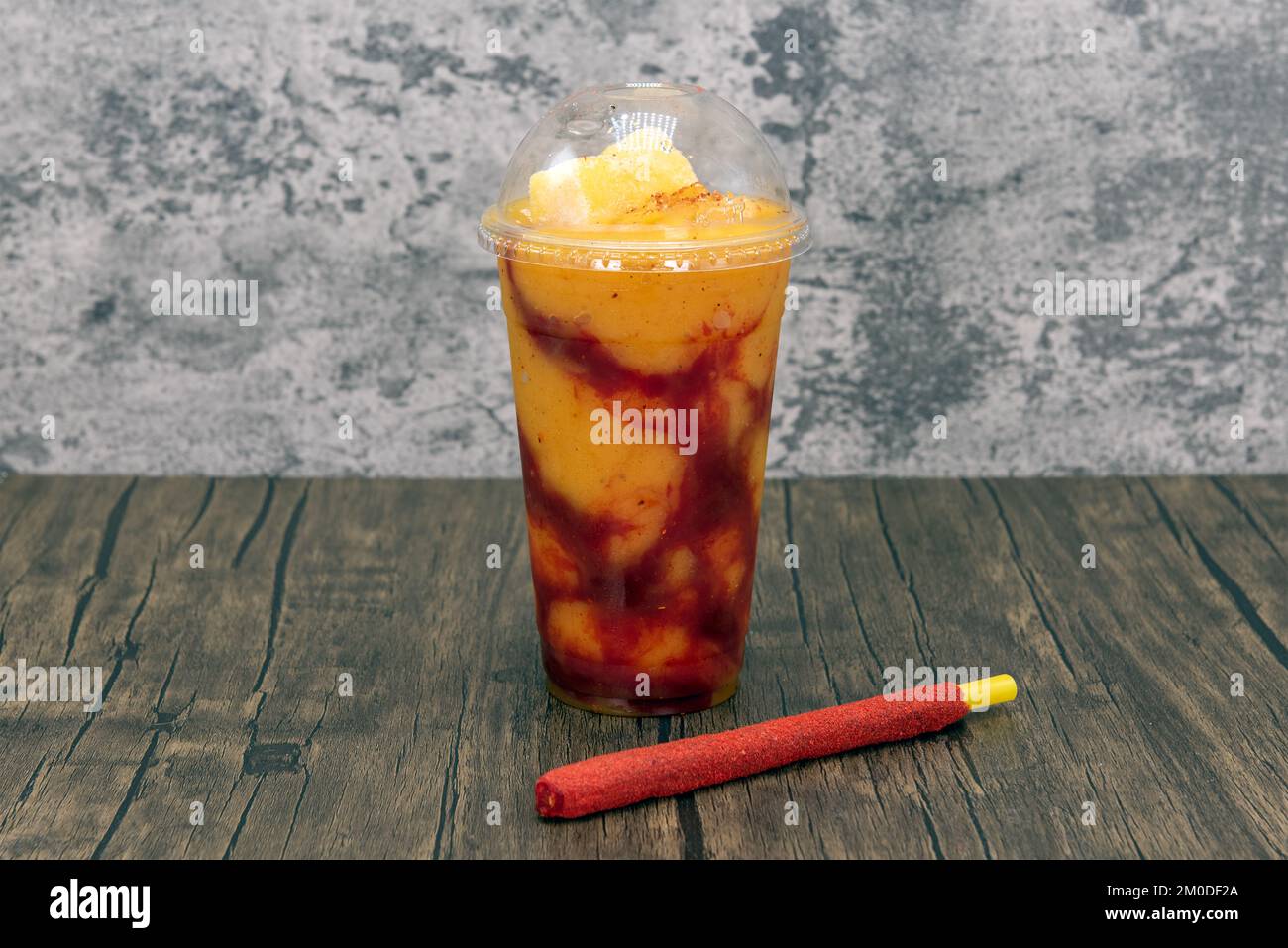 Sweet fruit flavored drink with large chunks of mango on top and sweet ...