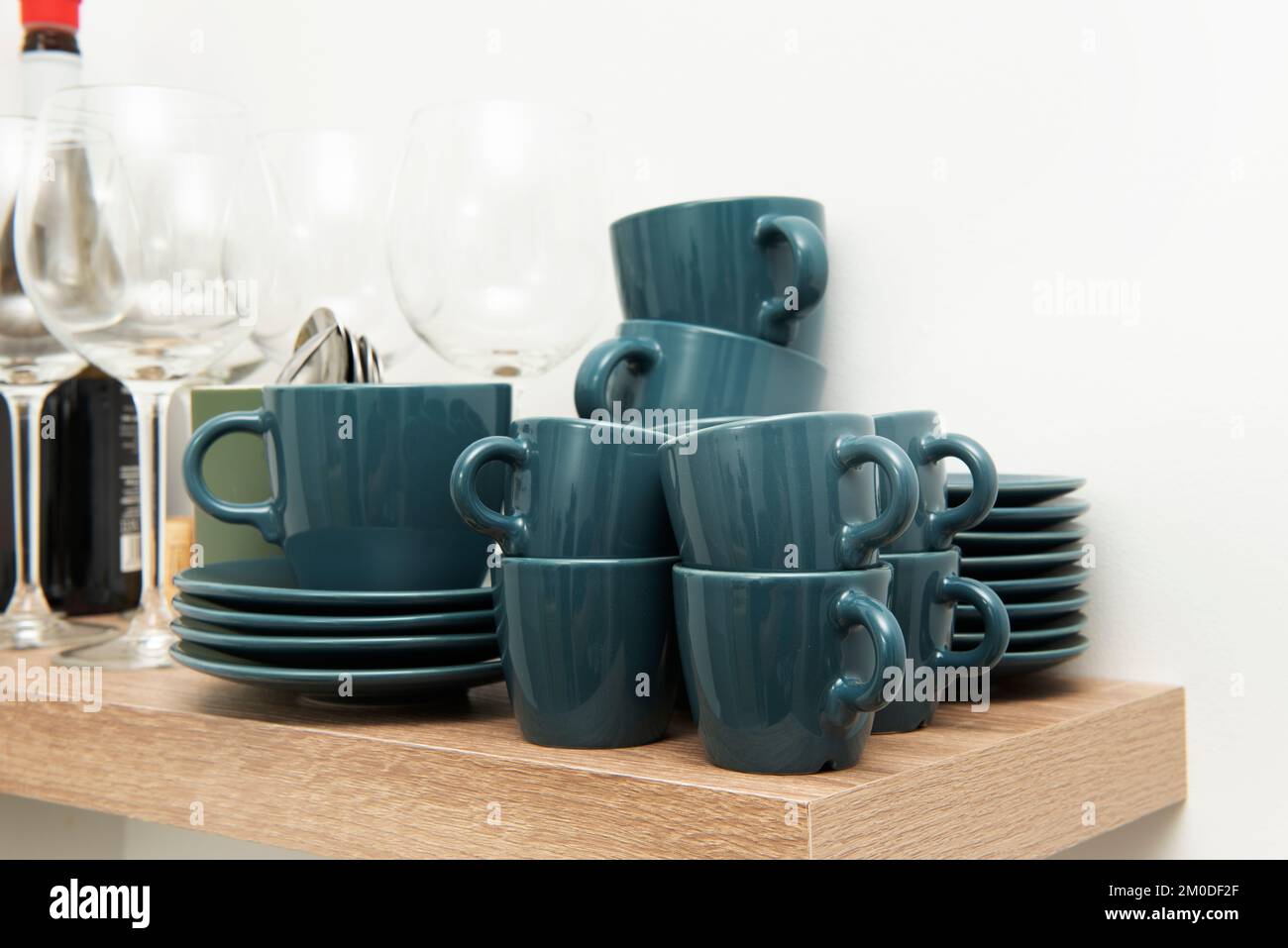 A blue colored china set with many matching saucers and cups alongside ...