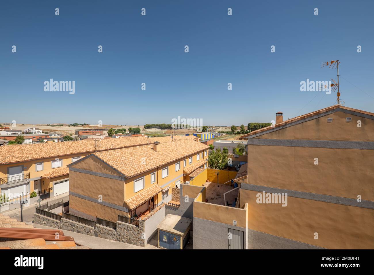 Urbanization with two-story houses with patios and common areas with ...