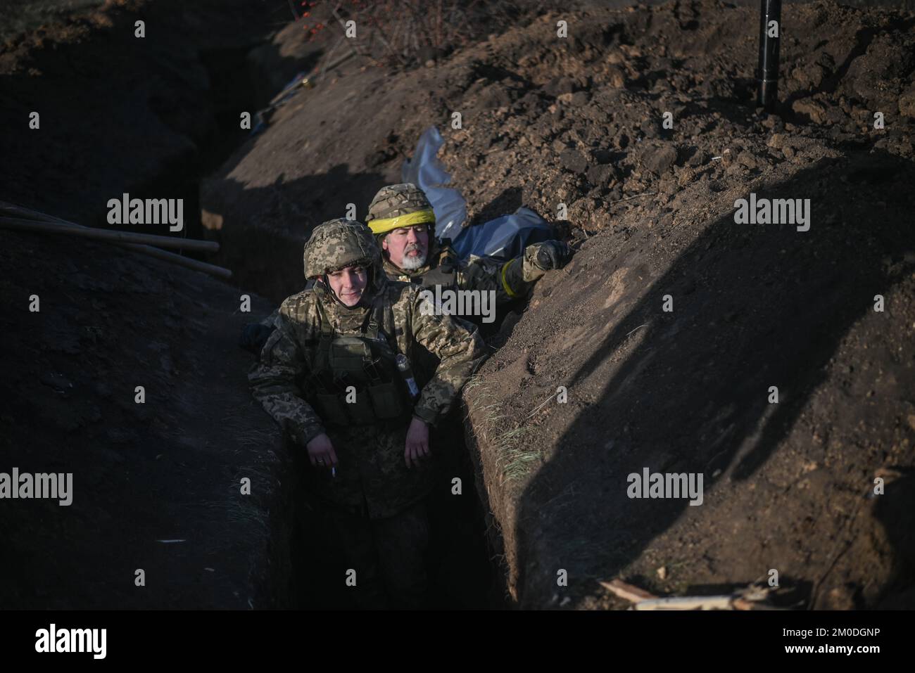 A Ukrainian chaplain and servicemember walks through a newly built ...