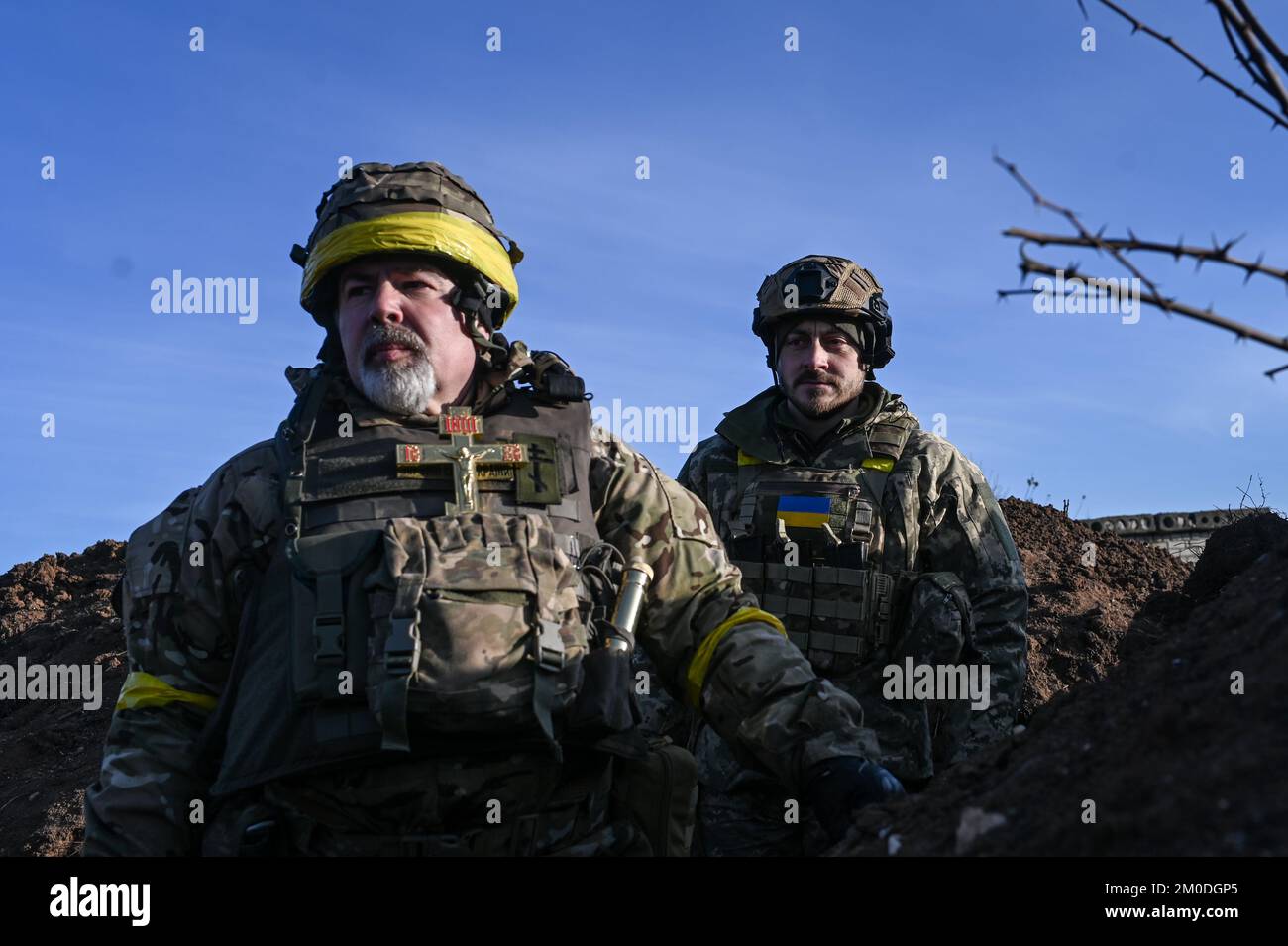 A Ukrainian chaplain and servicemember walks through a newly built ...