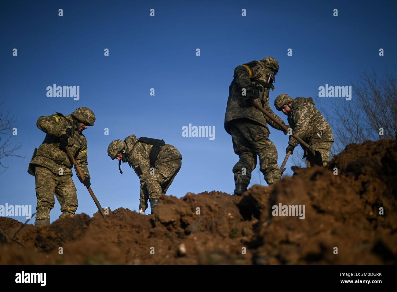 Ukrainian servicemembers dig new defensive trenches using shovels in ...