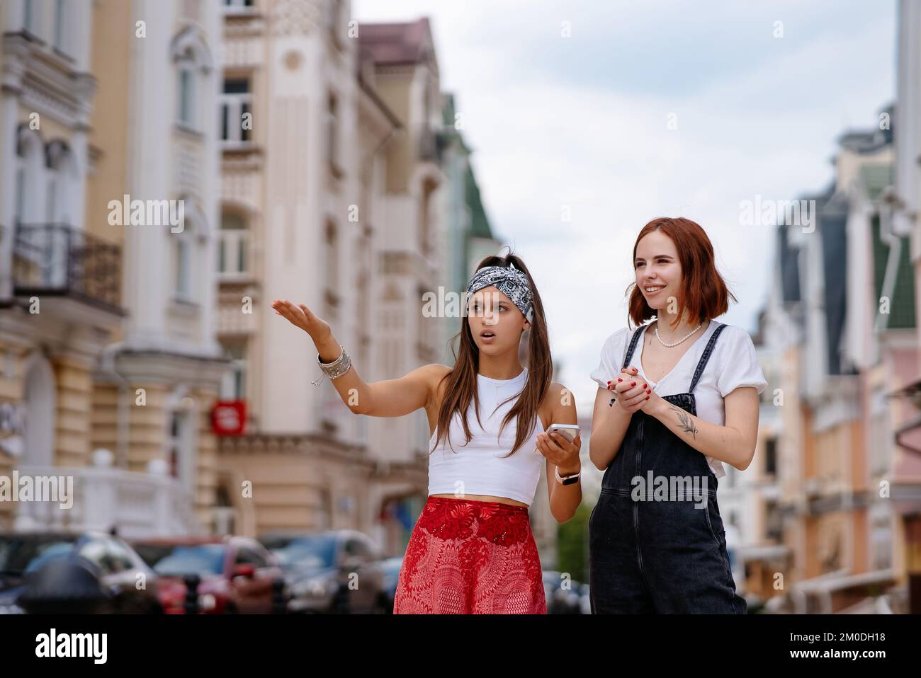 two young women walking outdoor having fun Stock Photo - Alamy