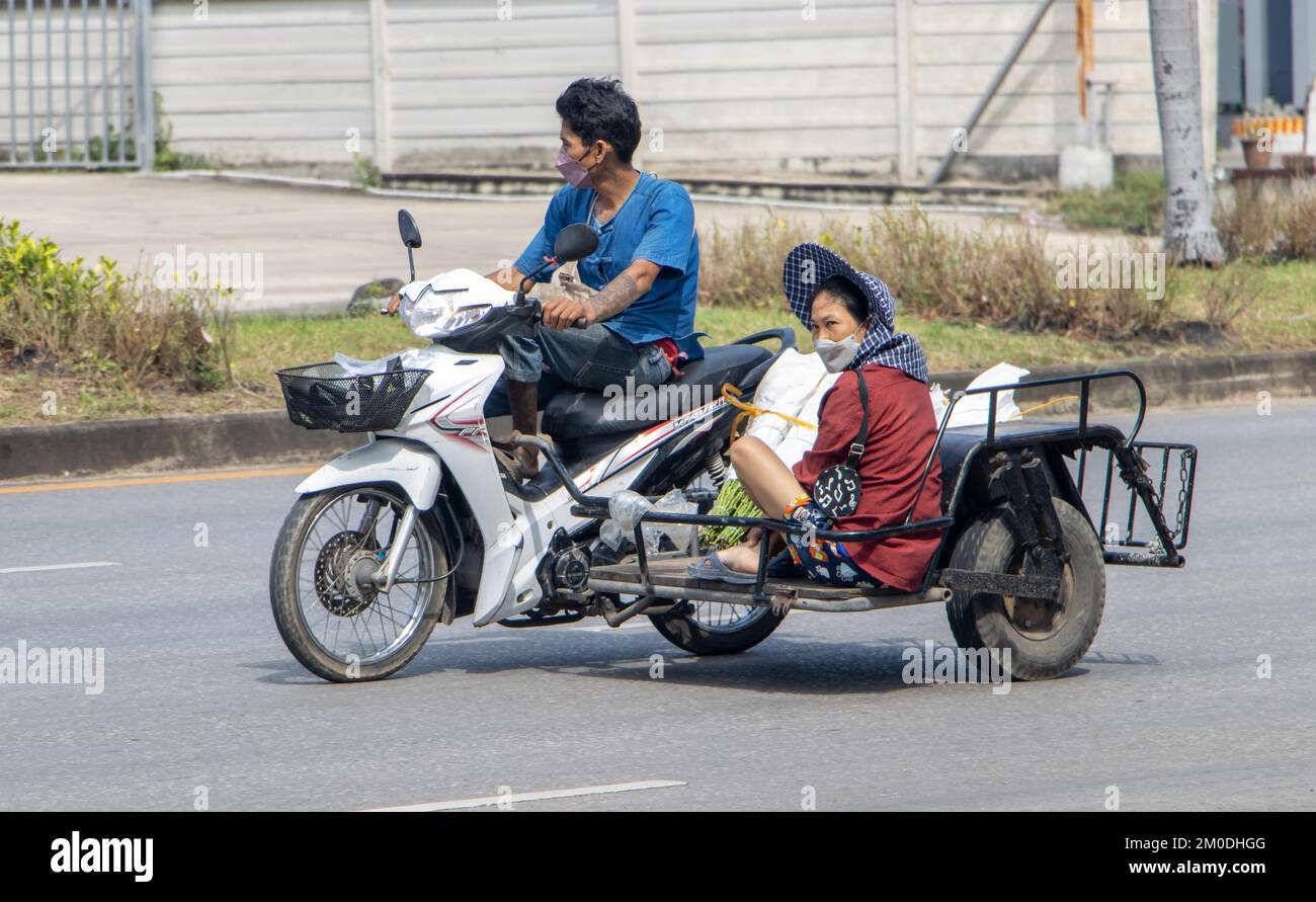 RATCHABURI, THAILAND, NOV 16 2022, A pair ride a motorcycle with a ...