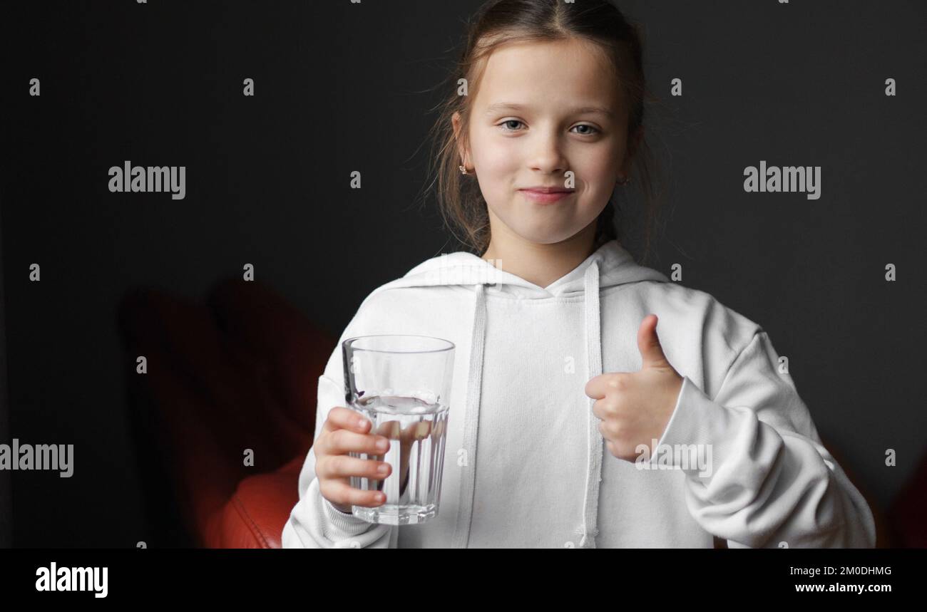 Little girl drinks fresh transparent pure filtered mineral water from ...