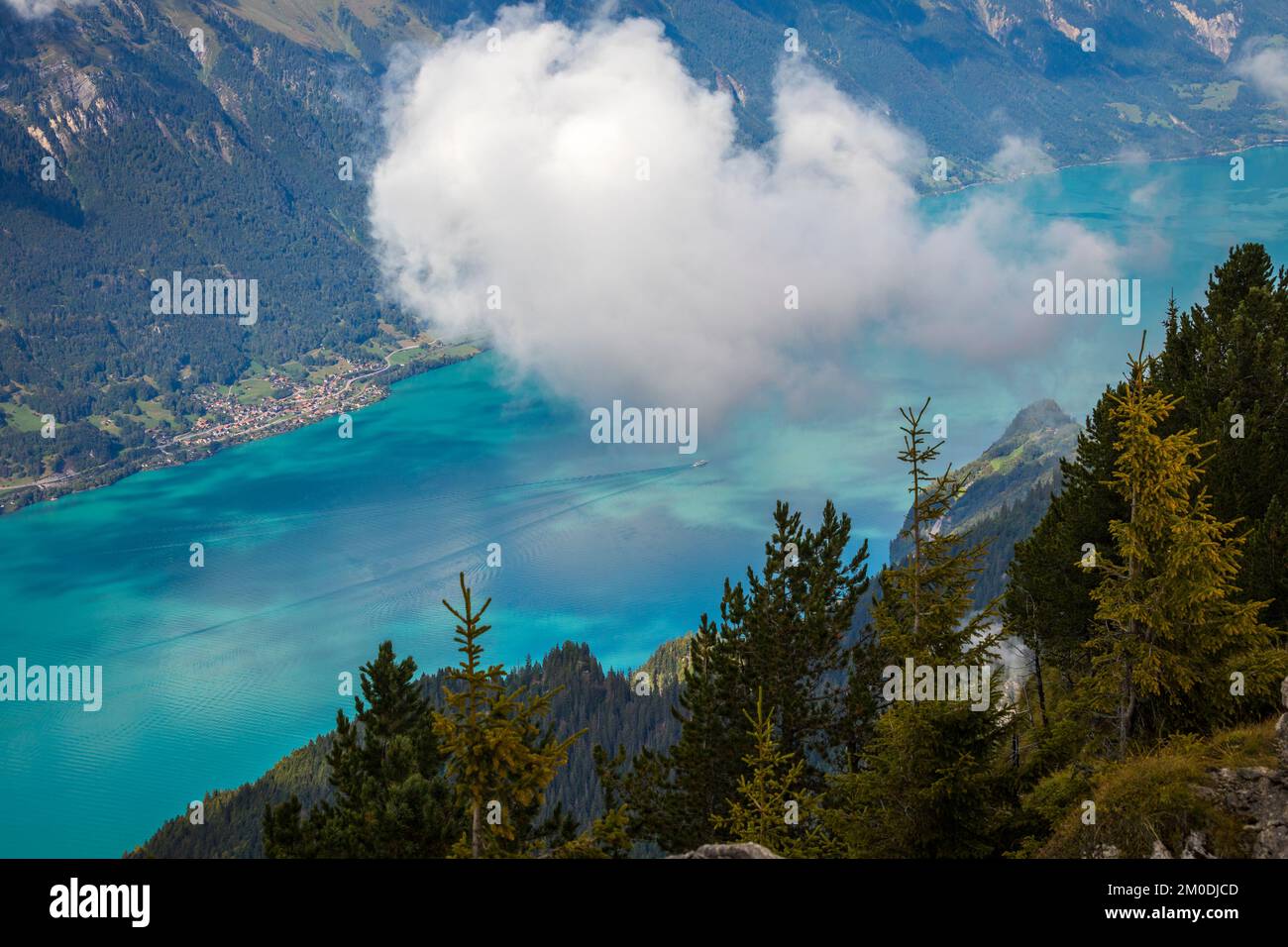 Aerial view of Swiss Alps and Lake Brienz with ferry boat at sunset ...