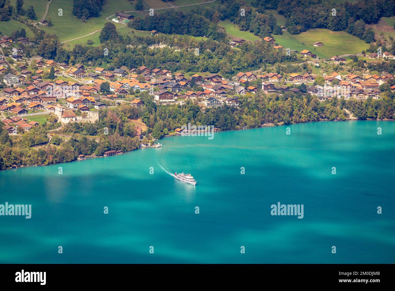 Aerial view of Swiss Alps and Lake Brienz with ferry boat at sunset ...