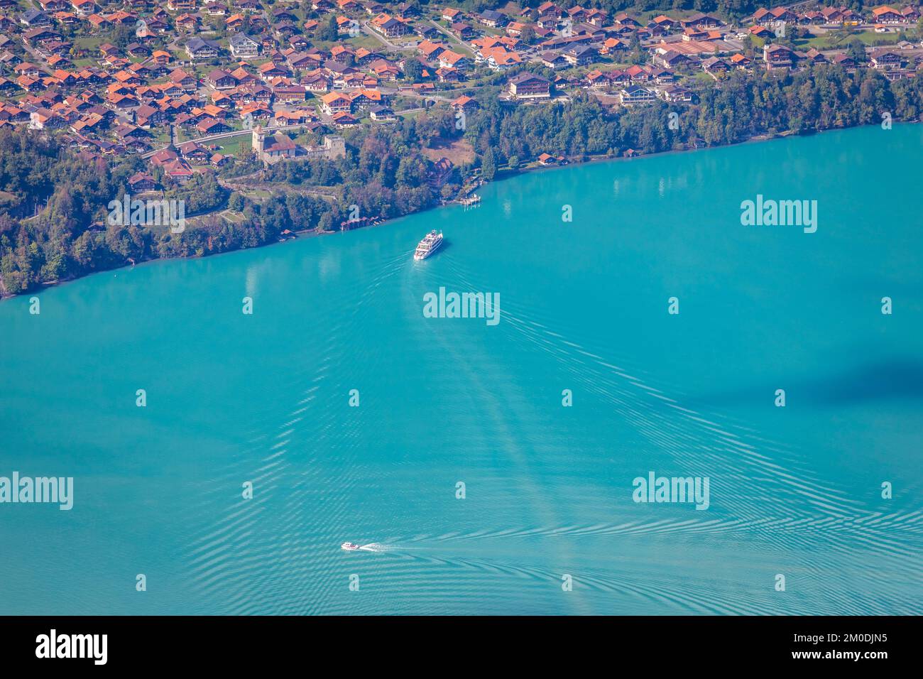 Aerial view of Swiss Alps and Lake Brienz with ferry boat at sunset ...