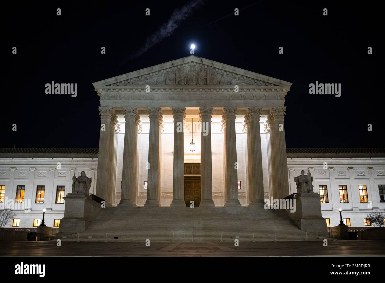 A general view of the U.S. Supreme Court with a waxing gibbous moon ...